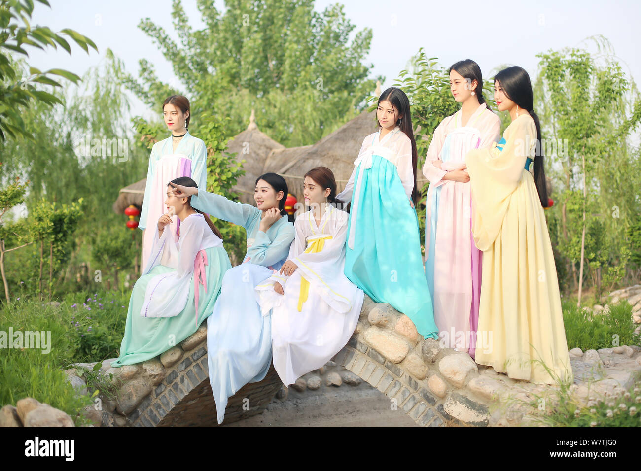 Female graduates dressed in traditional Chinese costumes pose for ...