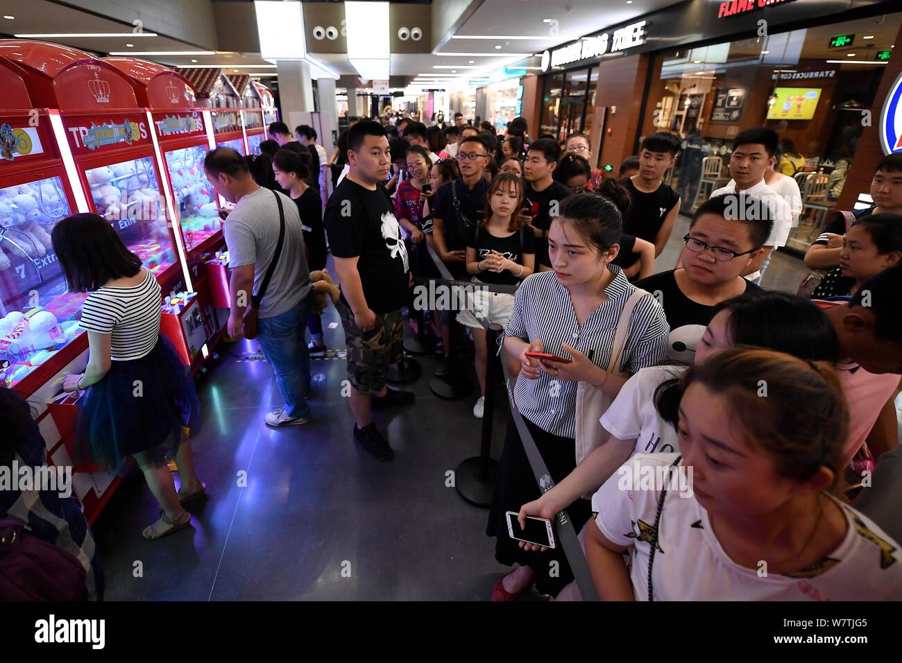 Competitors queue up to take part in a doll-grabbing competition at N1 ...