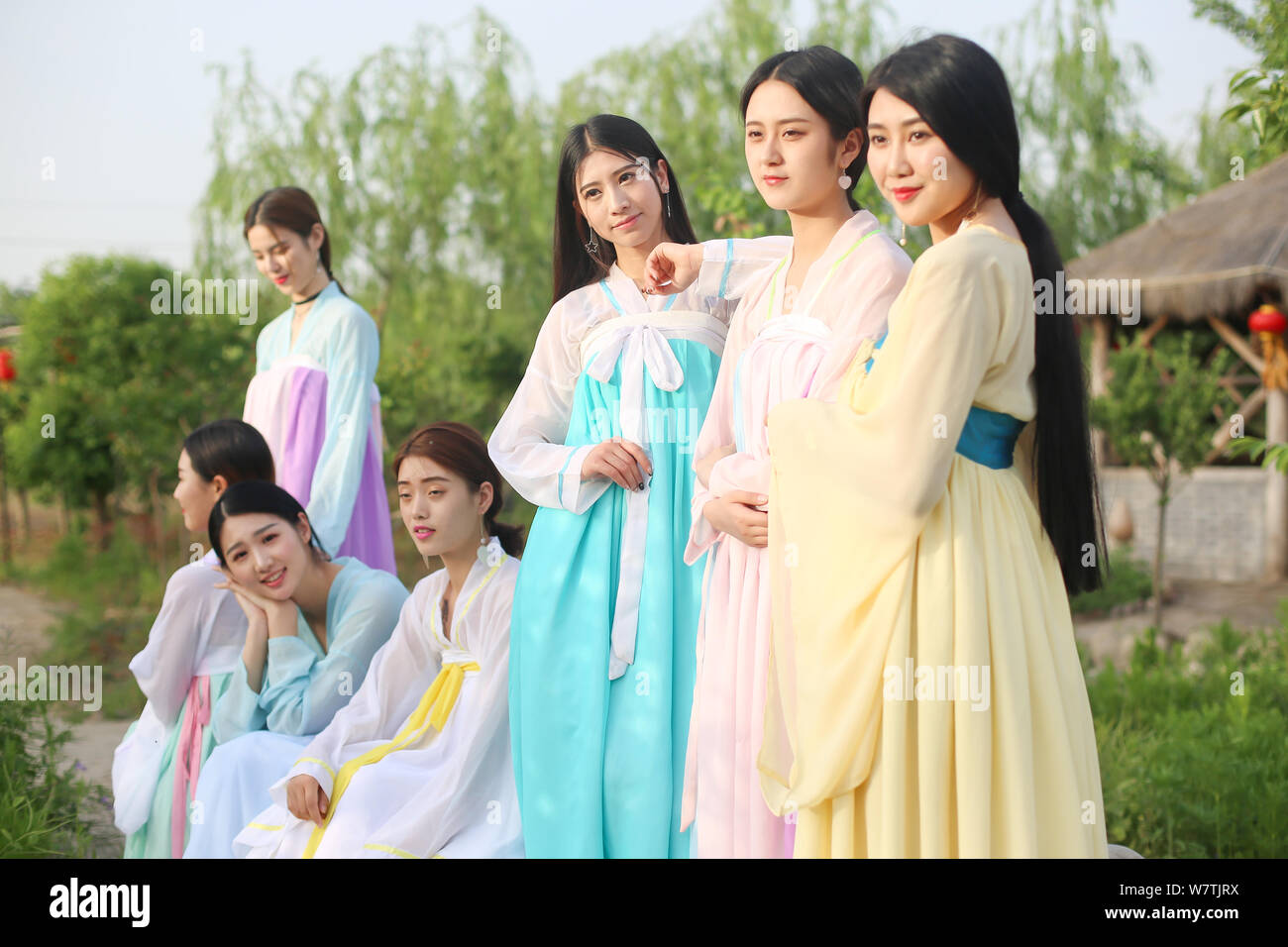 Female graduates dressed in traditional Chinese costumes pose for ...