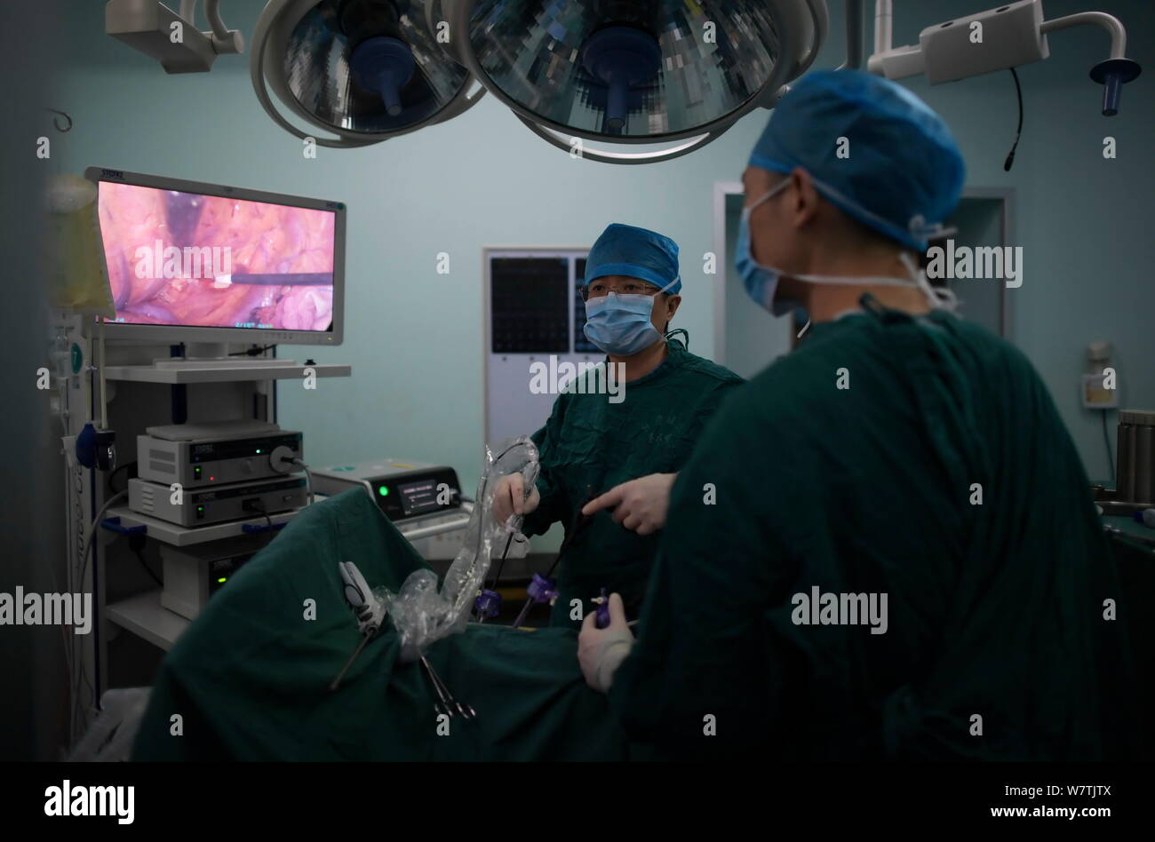 Chinese doctor Jiang Yuequan conducts a surgery on a patient at a tumor ...