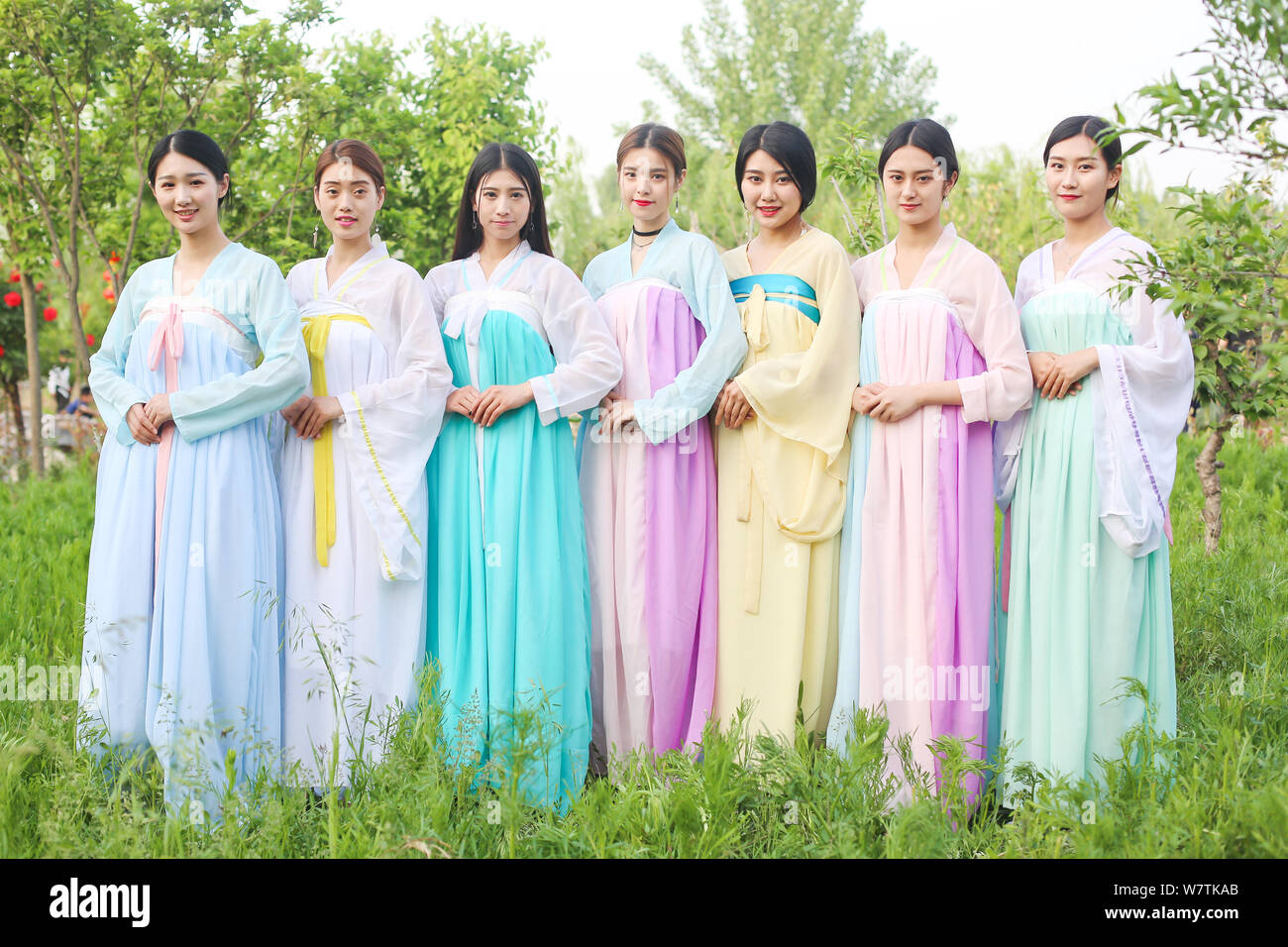 Female graduates dressed in traditional Chinese costumes pose for ...