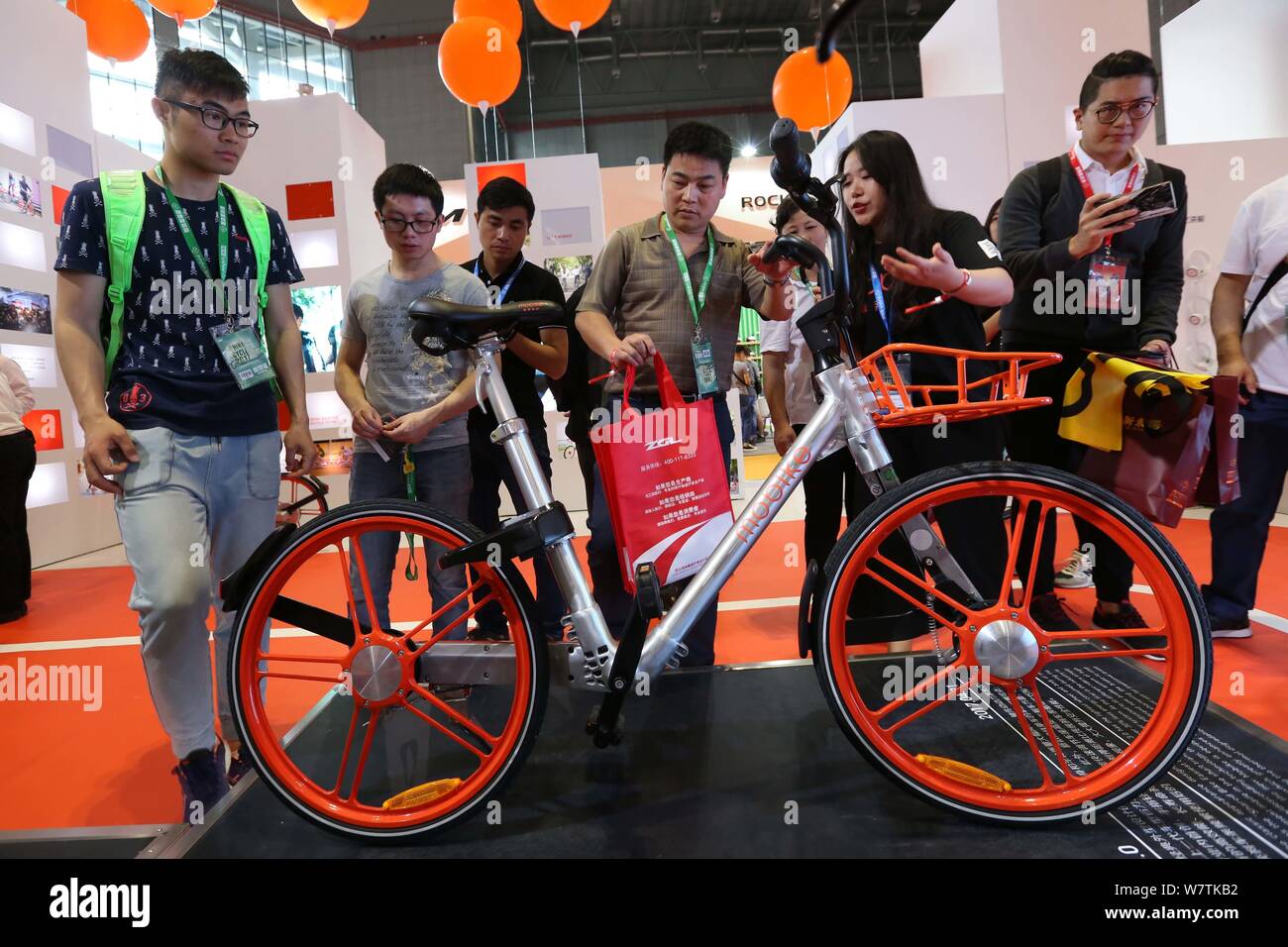 Visitors are pictured at the stand of Chinese bike-sharing services ...