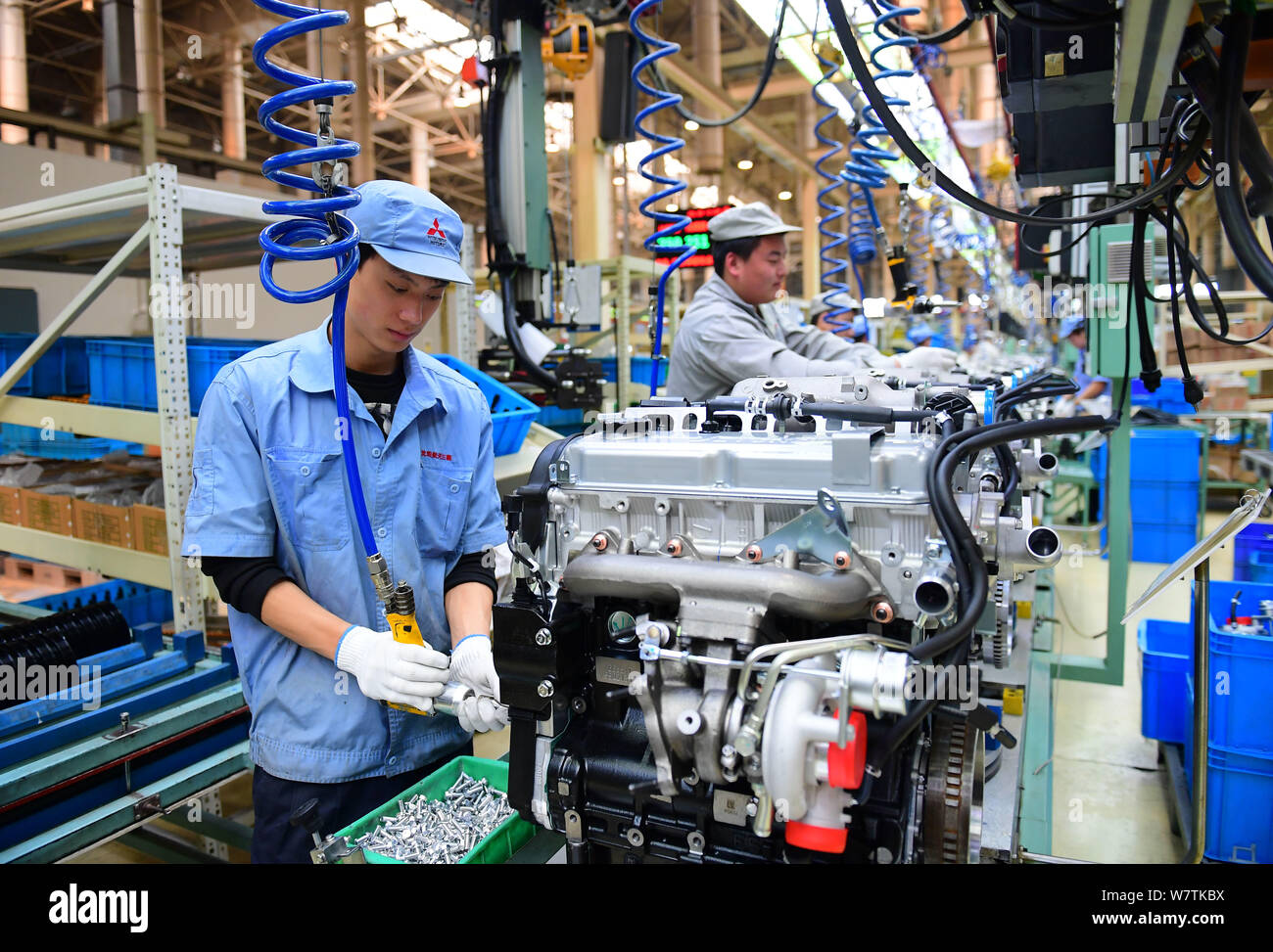 --FILE--Chinese workers assemble engines for autos at a plant of ...
