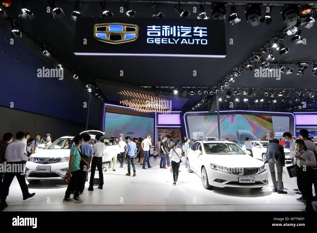 --FILE--People visit the stand of Geely during the 14th China ...