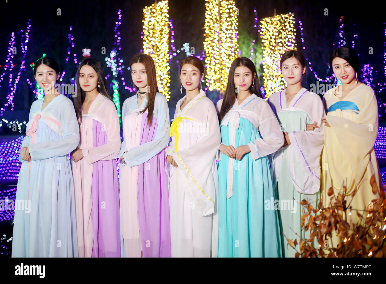 Female graduates dressed in traditional Chinese costumes pose for ...