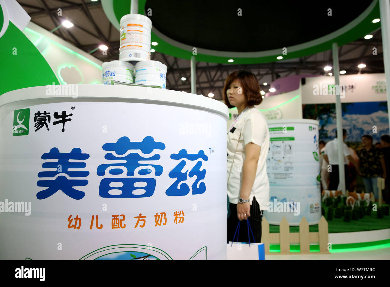 --FIN--A visitor walks past the stand of Milex infant formula of ...