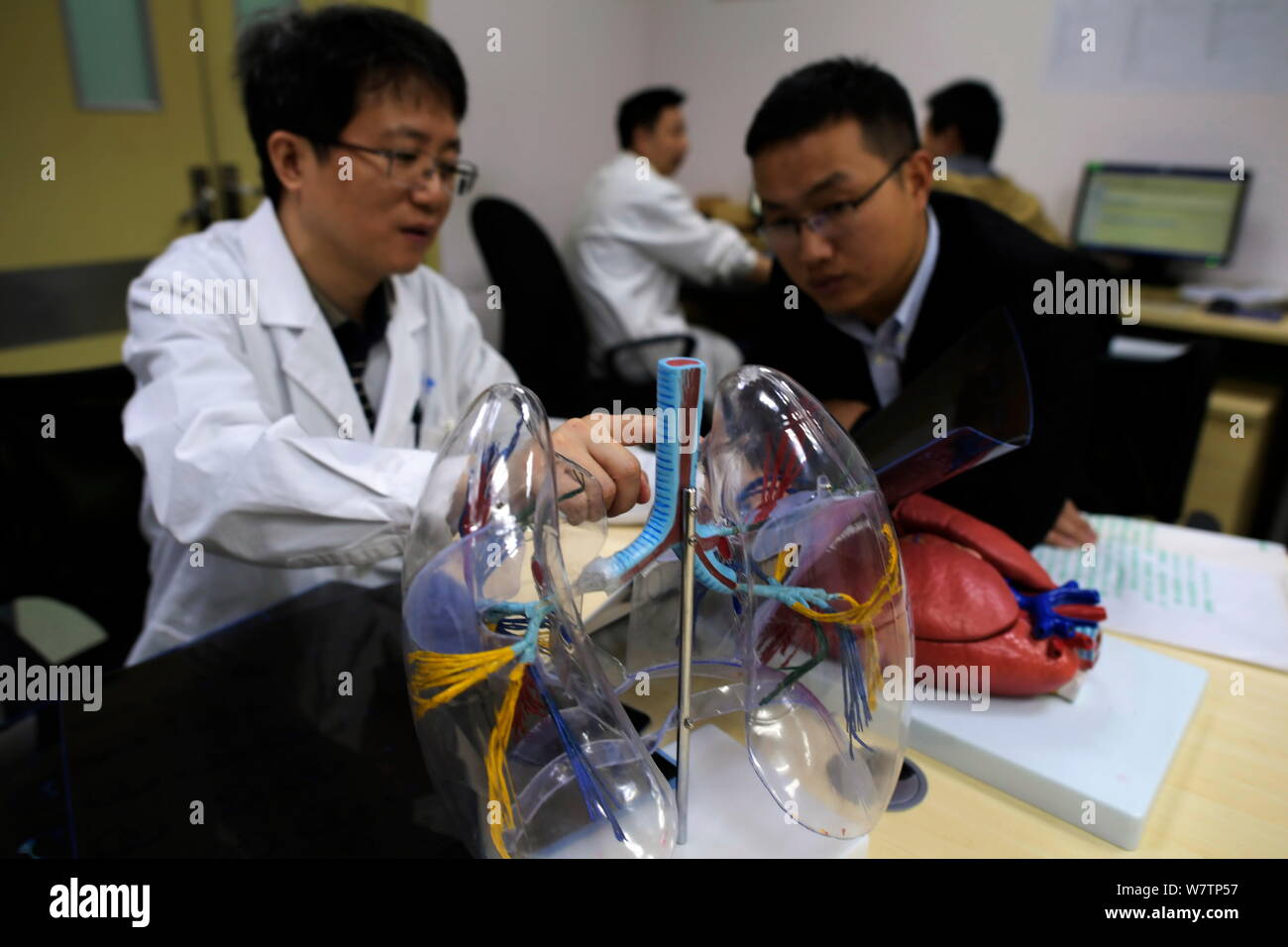 Chinese doctor Jiang Yuequan sees a patient at a tumor hospital in ...