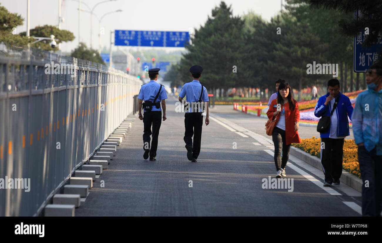 Chinese police officers patrol the China National Convention Center ...
