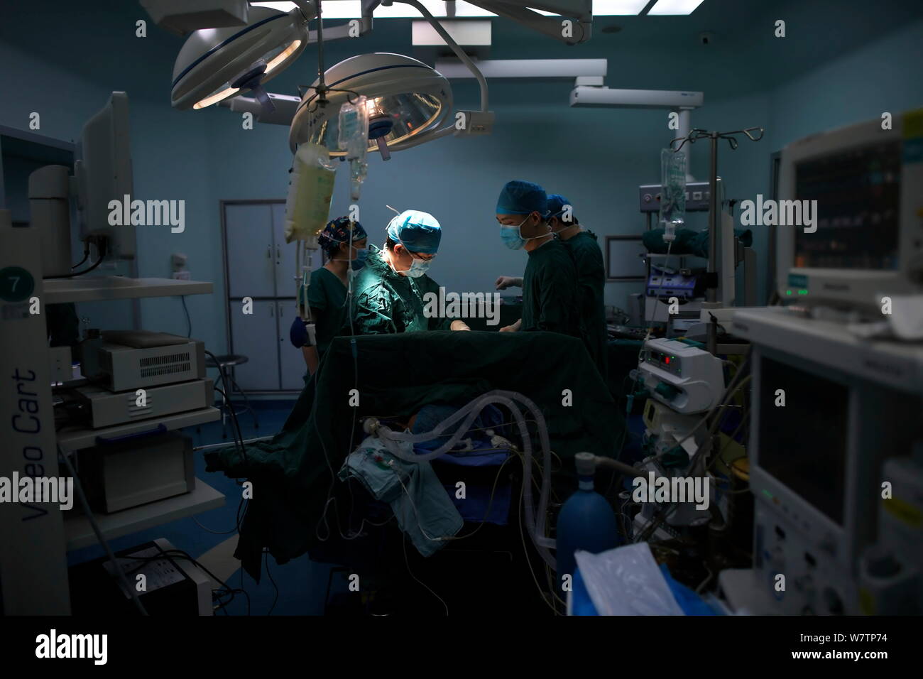 Chinese doctor Jiang Yuequan conducts a surgery on a patient at a tumor ...