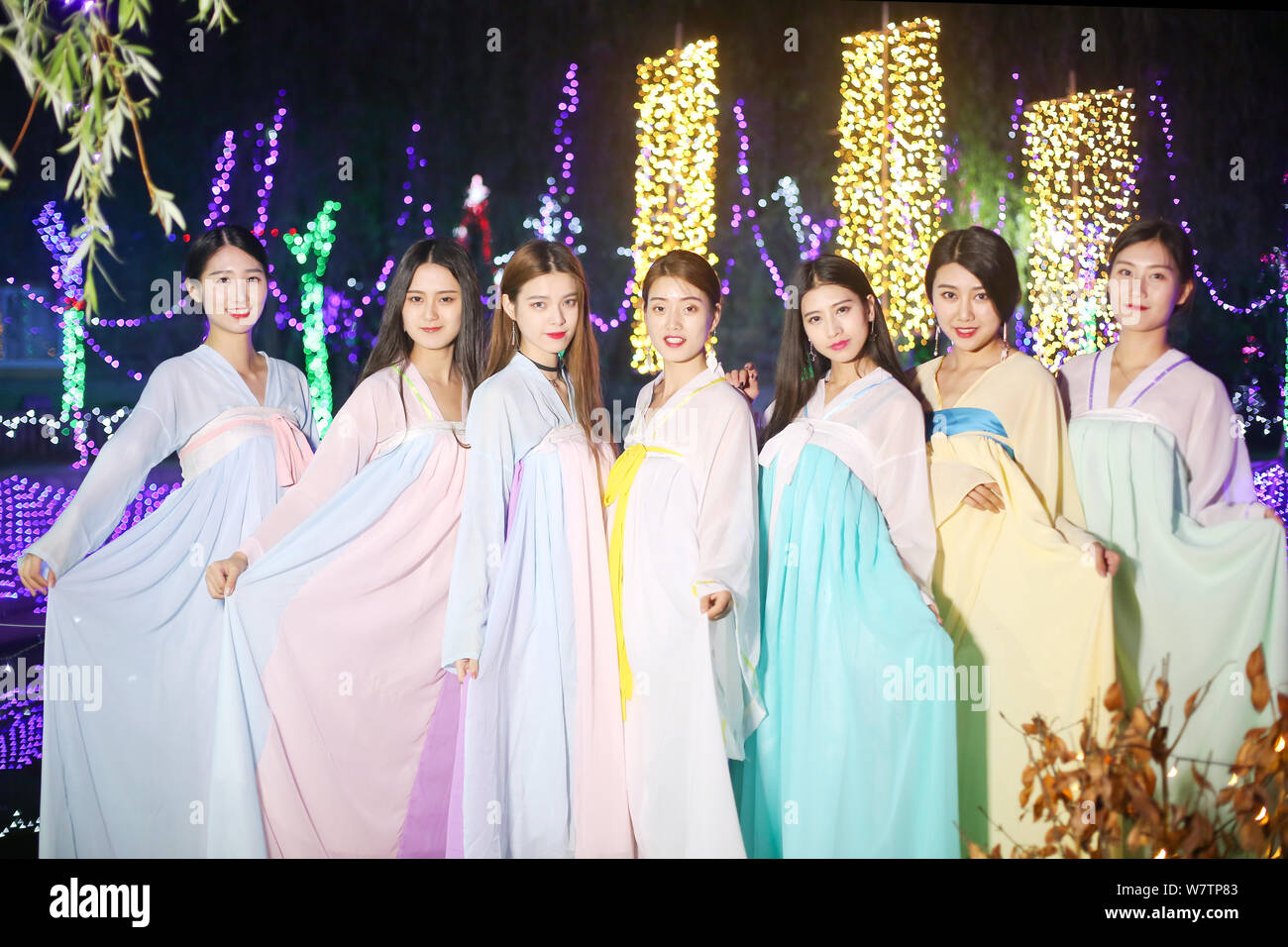 Female graduates dressed in traditional Chinese costumes pose for ...