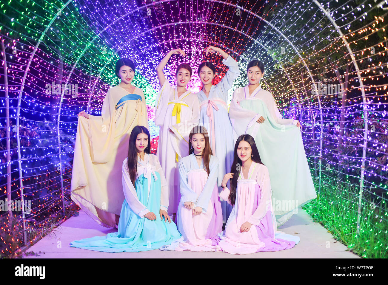 Female graduates dressed in traditional Chinese costumes pose for ...
