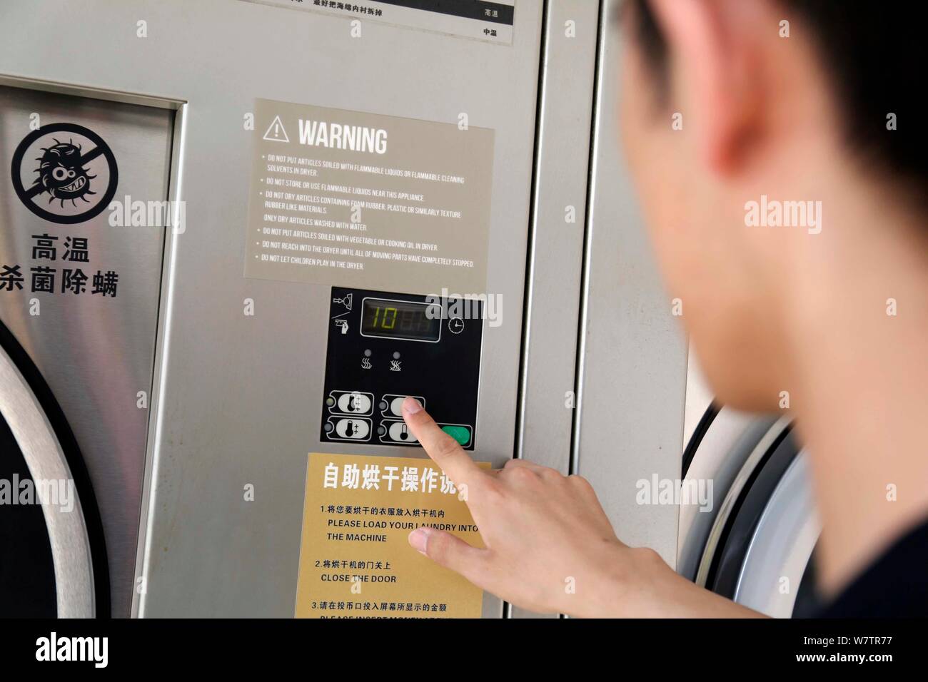 A customer uses a public washing machine installed outside a mall in ...