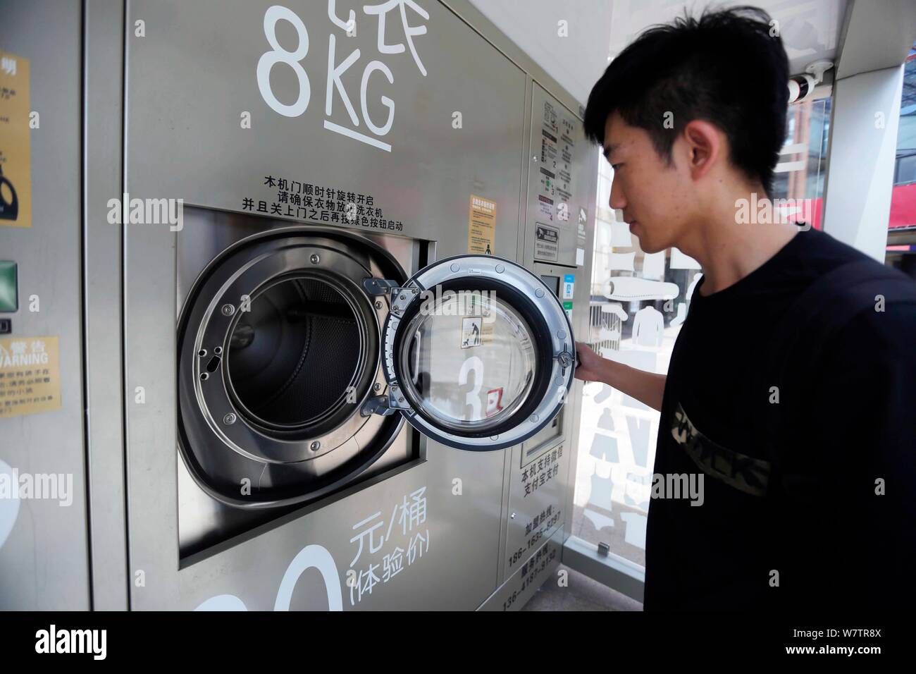 A customer uses a public washing machine installed outside a mall in ...