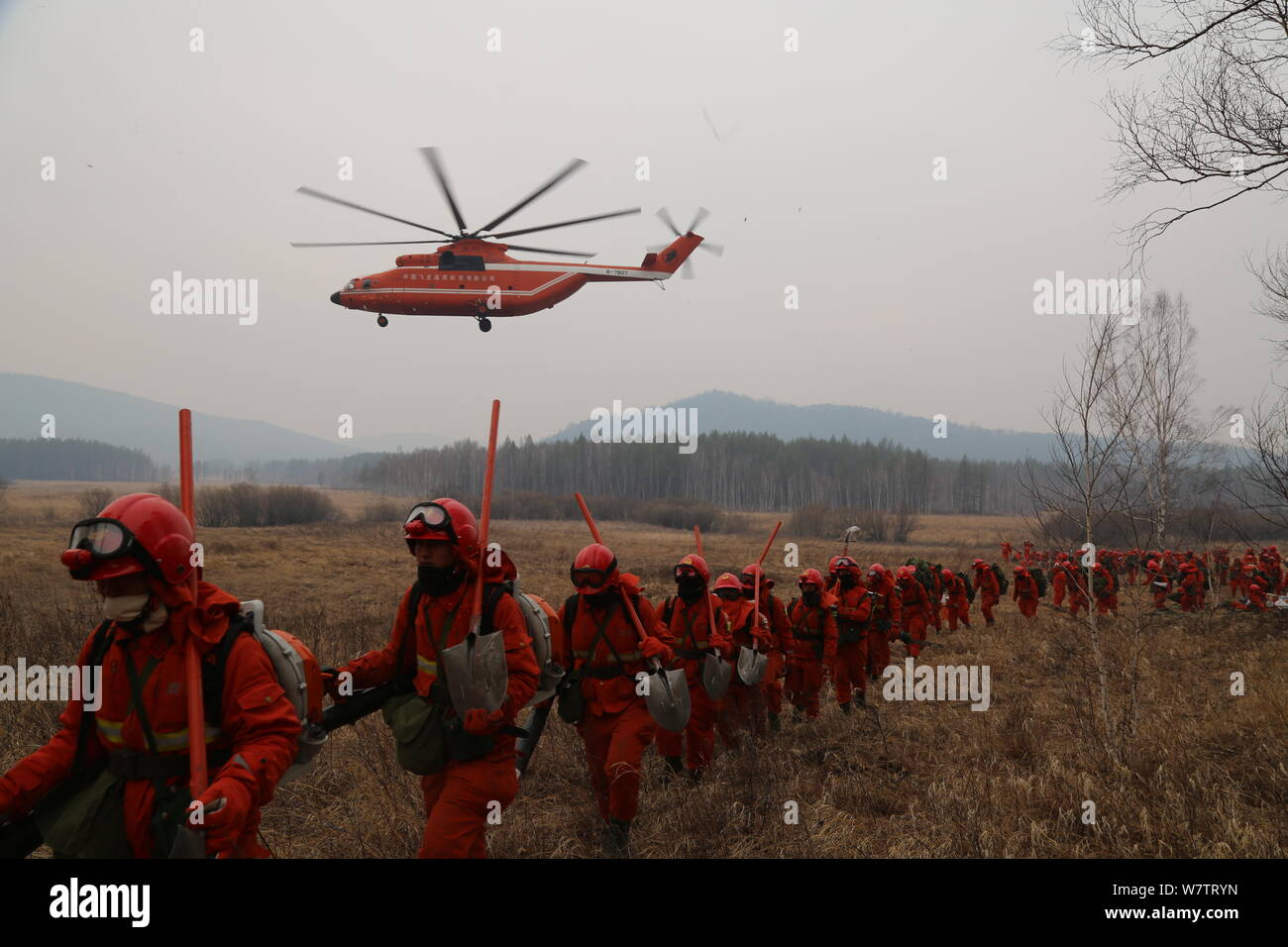 Chinese firefighters march the site where fire was caught in the Bilahe ...