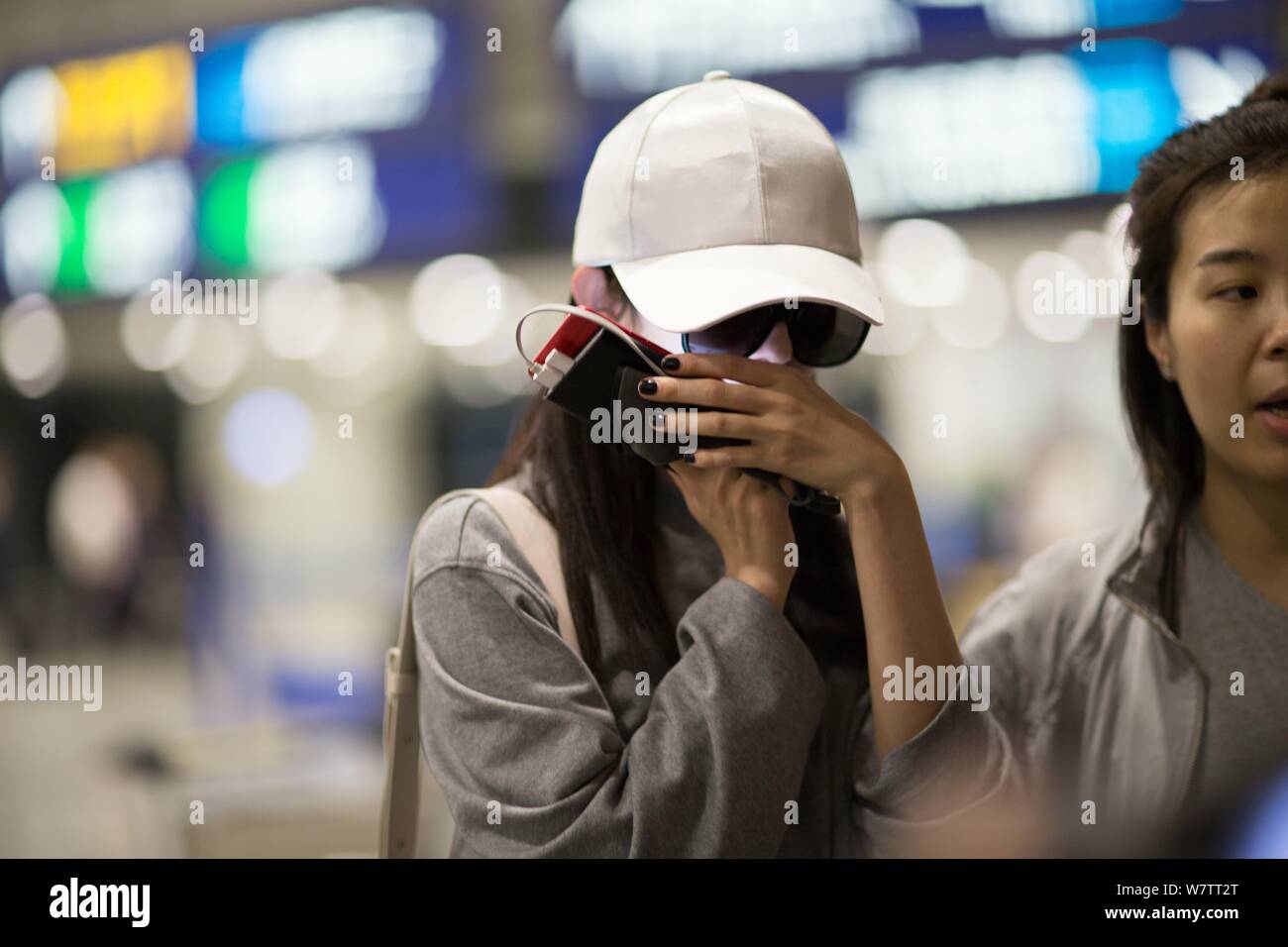 Chinese actress Yang Mi uses her smartphone at the Shanghai Pudong ...