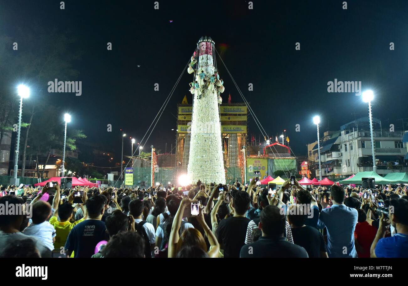 Participants climb up the bun mountain during the bun snatching ...