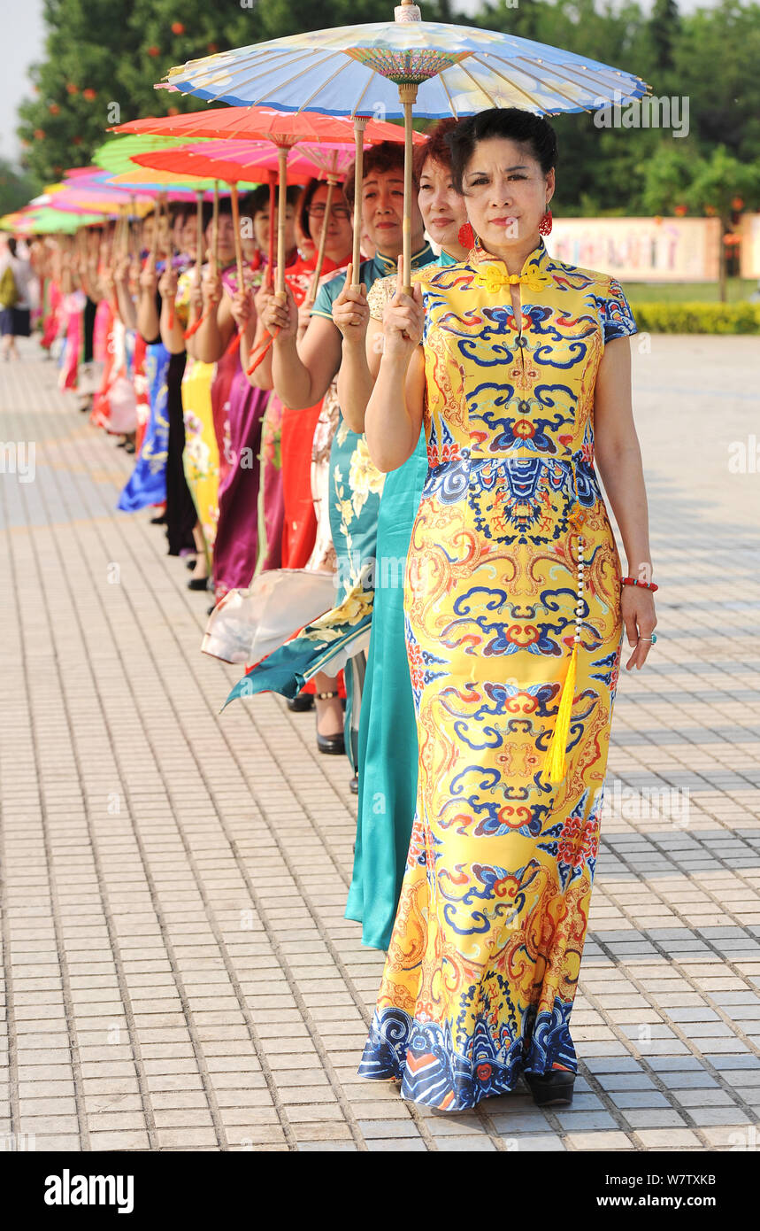 Women present cheongsam, a traditional Chinese women's dress also known ...