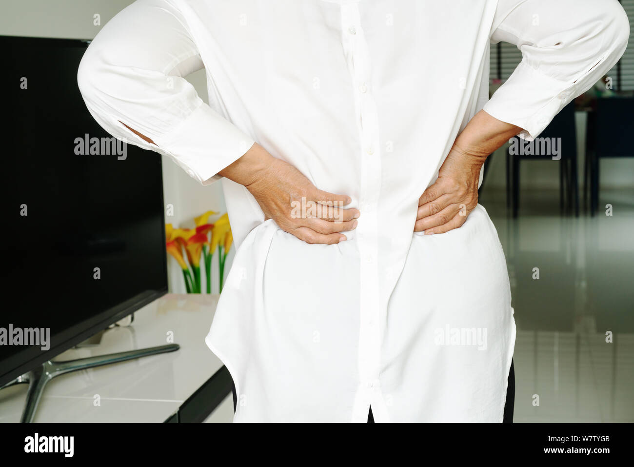 Old woman back pain at home, health problem concept Stock Photo - Alamy