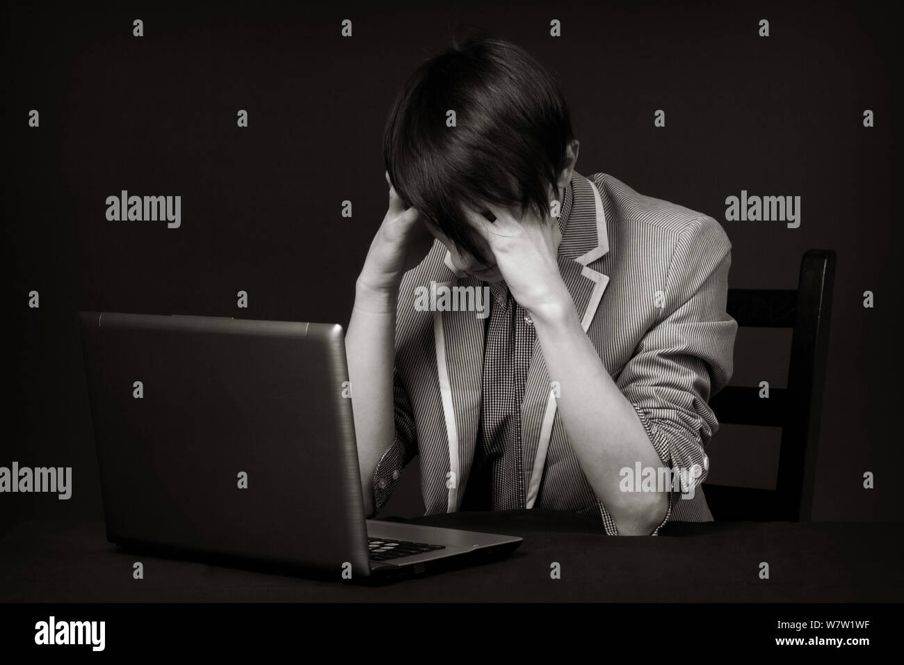 Depressed guy sitting in front of computer Stock Photo - Alamy