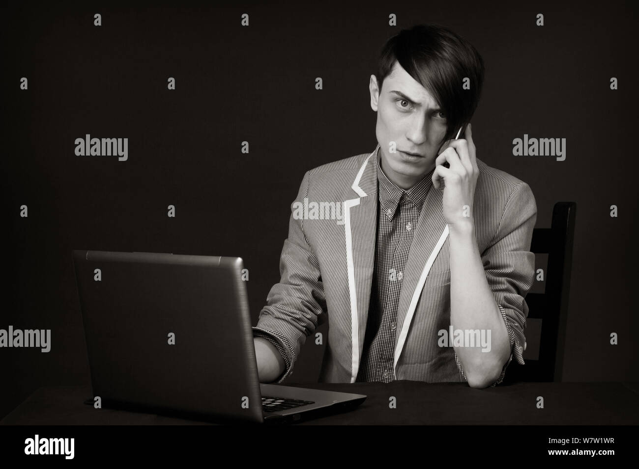 Young attractive guy talking on the phone, studio picture Stock Photo ...