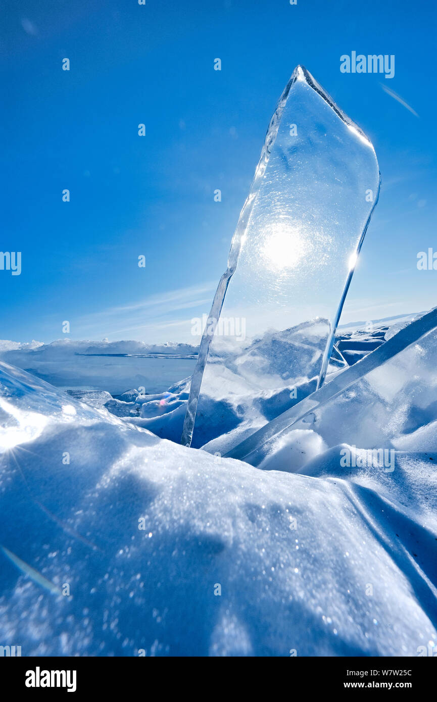 Sun shining through a clear pane of ice on sunny day, Lake Baikal ...