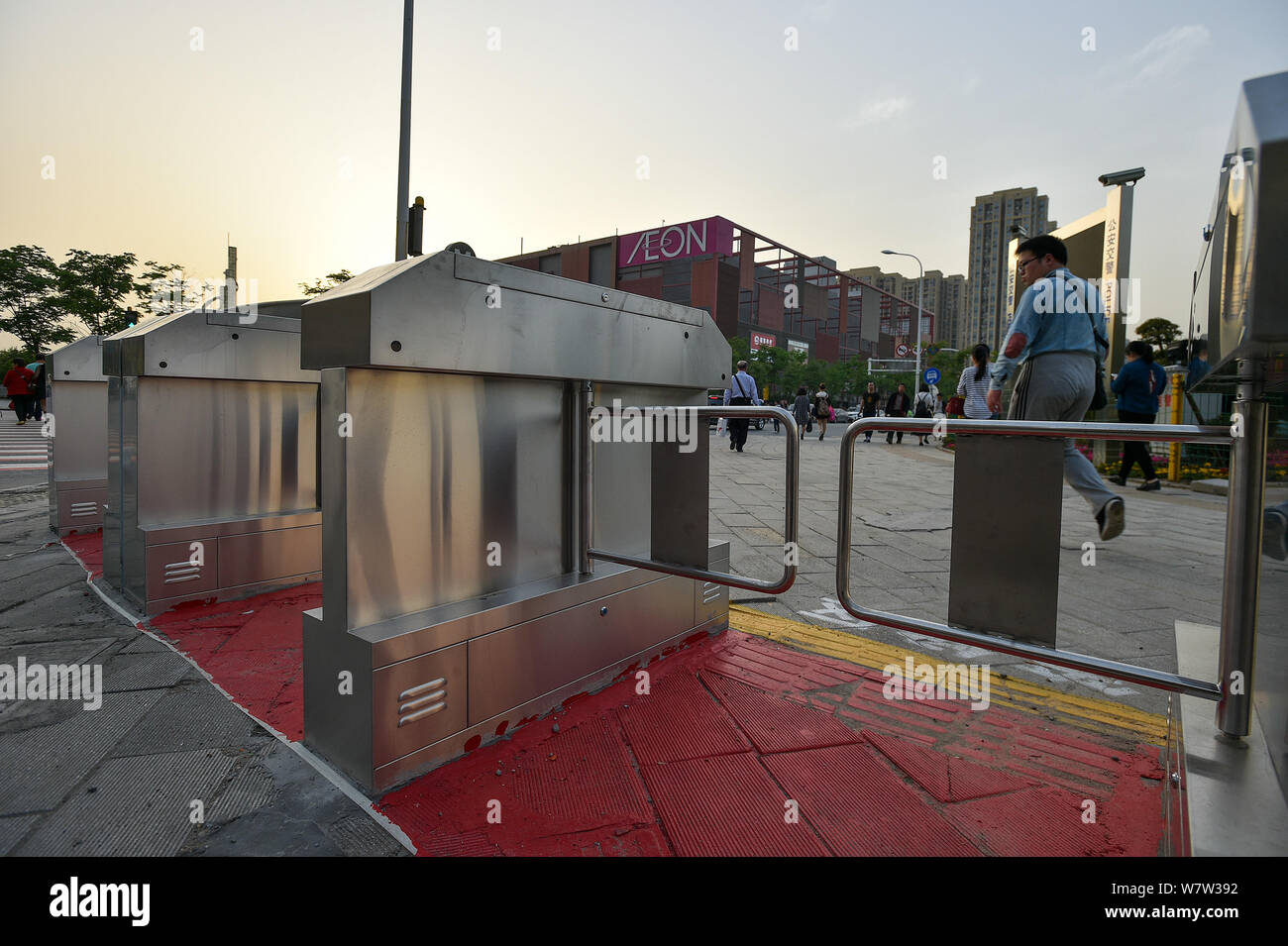 A pedestrian walks past newly installed crosswalk gates, which shut ...