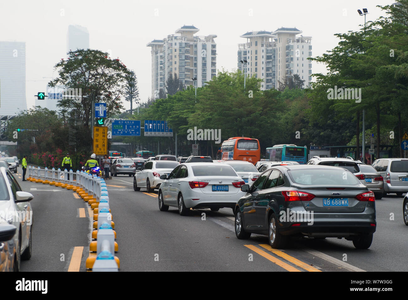 Vehicles drive on a reversible lane with a guardrail controlled by ...