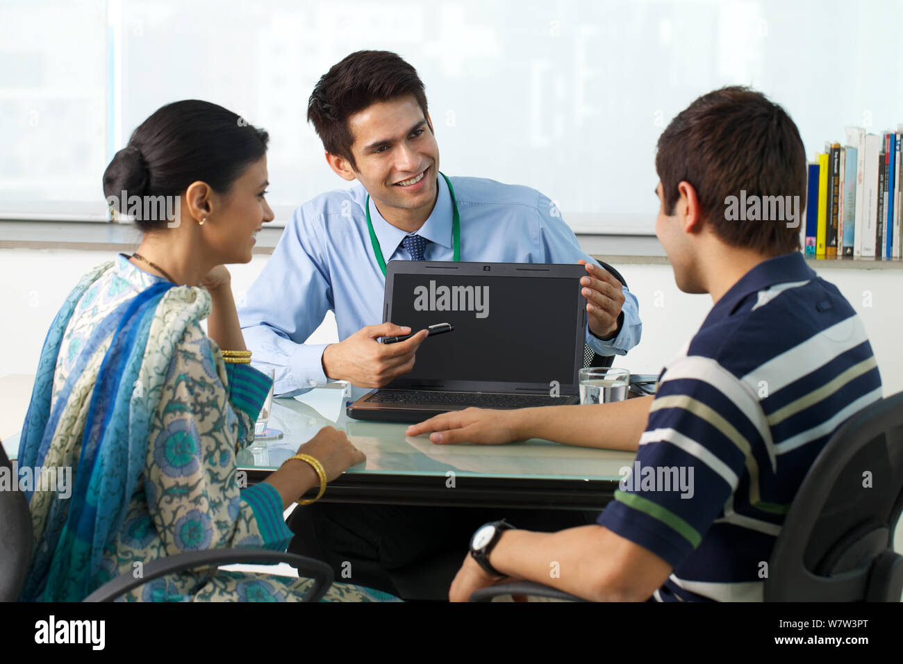 Real estate agent showing house plan on laptop Stock Photo - Alamy