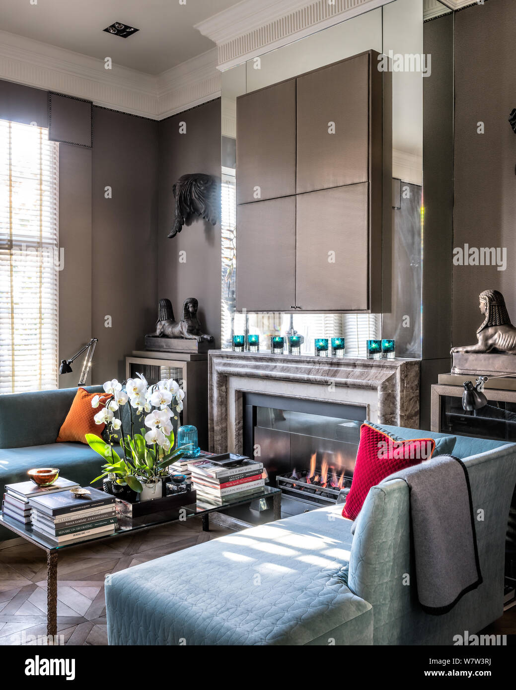 Lit fire in contemporary living room Stock Photo - Alamy