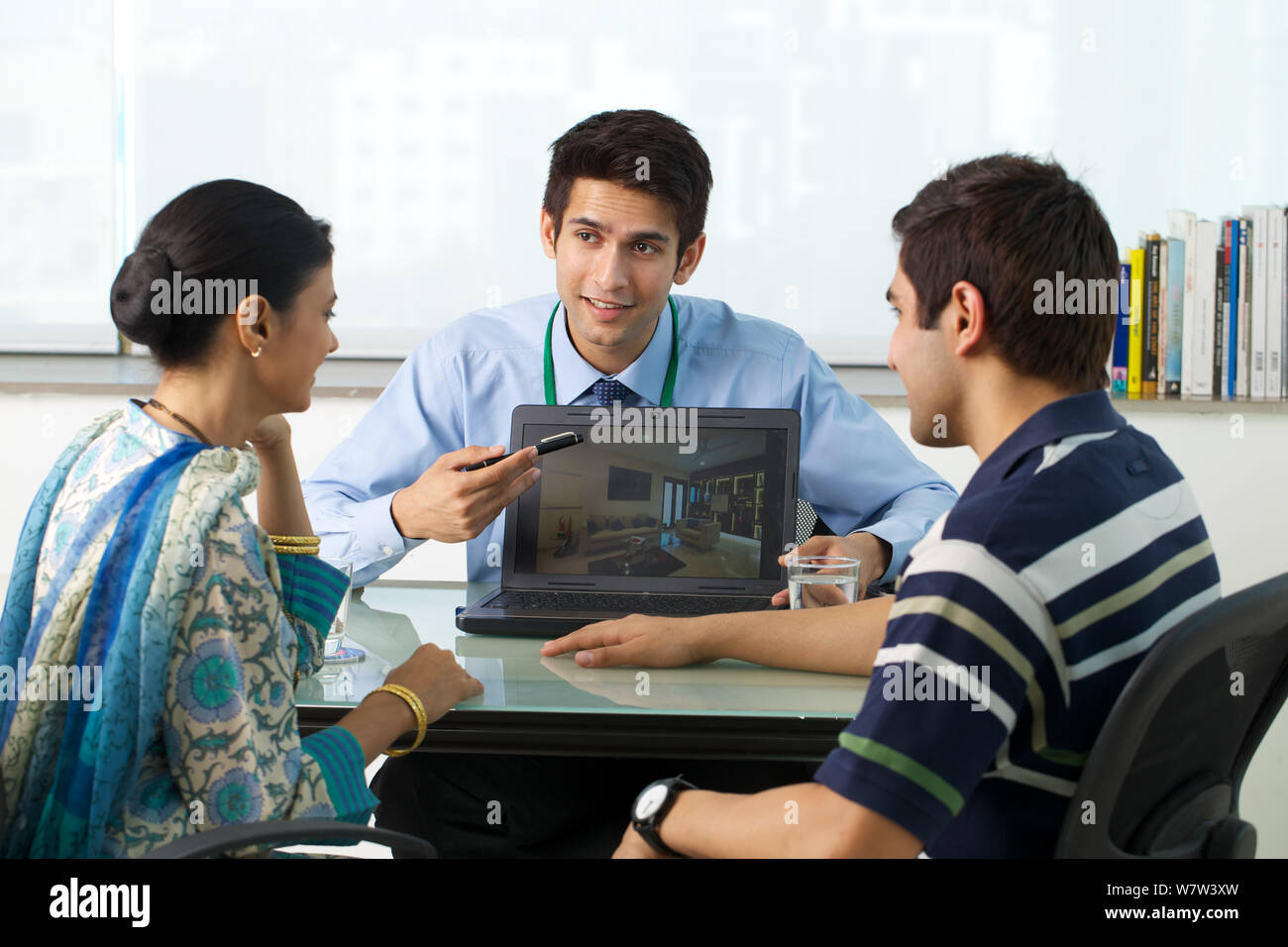 Real estate agent showing house plan on laptop Stock Photo - Alamy