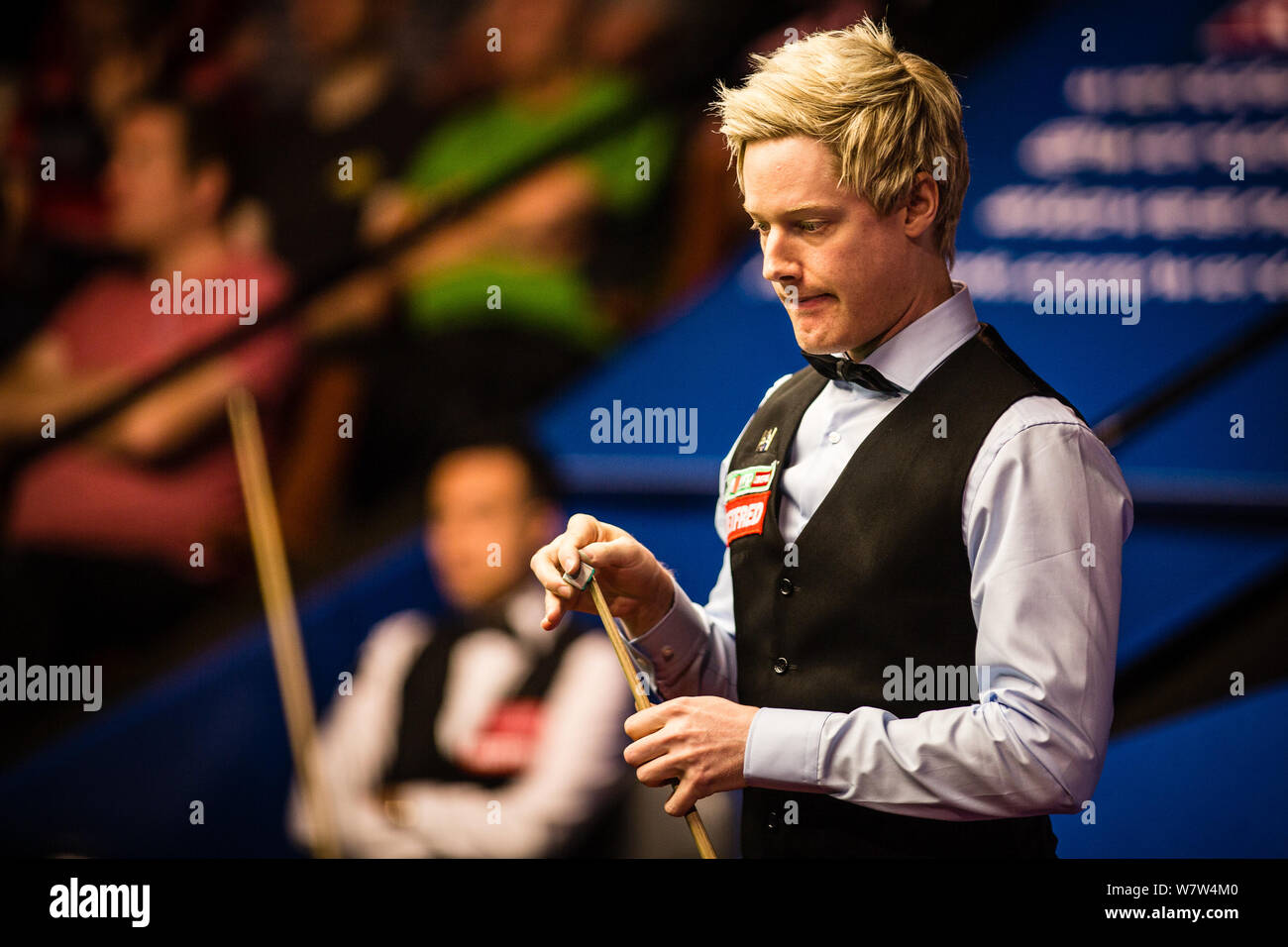 Jimmy Robertson of England chalks his cue as he considers a shot to ...