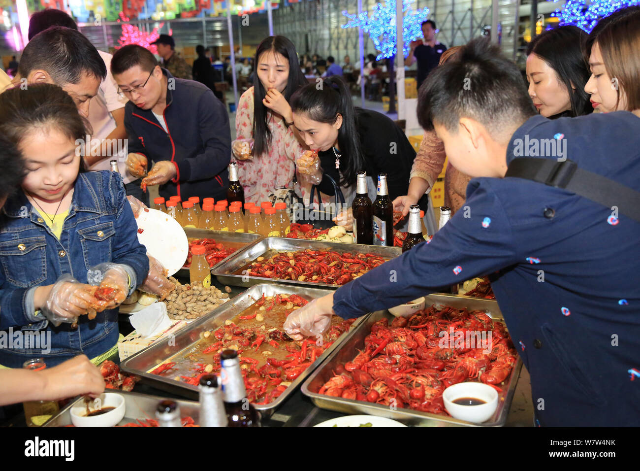 Chinese foodies eat crayfish during a feast held by a gourmet plaza to ...