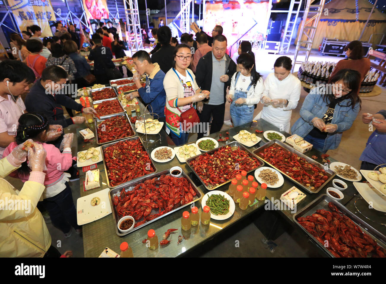 Chinese foodies eat crayfish during a feast held by a gourmet plaza to ...