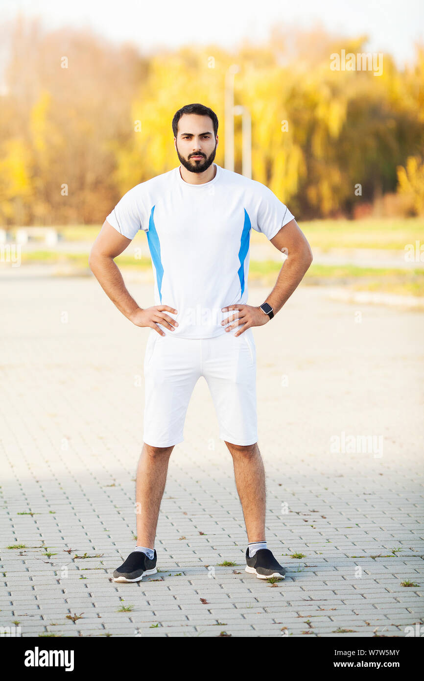 Fitness. Tired man runner rest after running on city stree Stock Photo ...