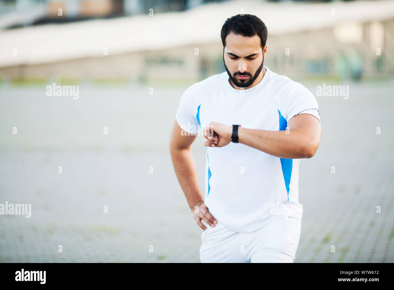 Fitness. Tired man runner rest after running on city stree Stock Photo ...