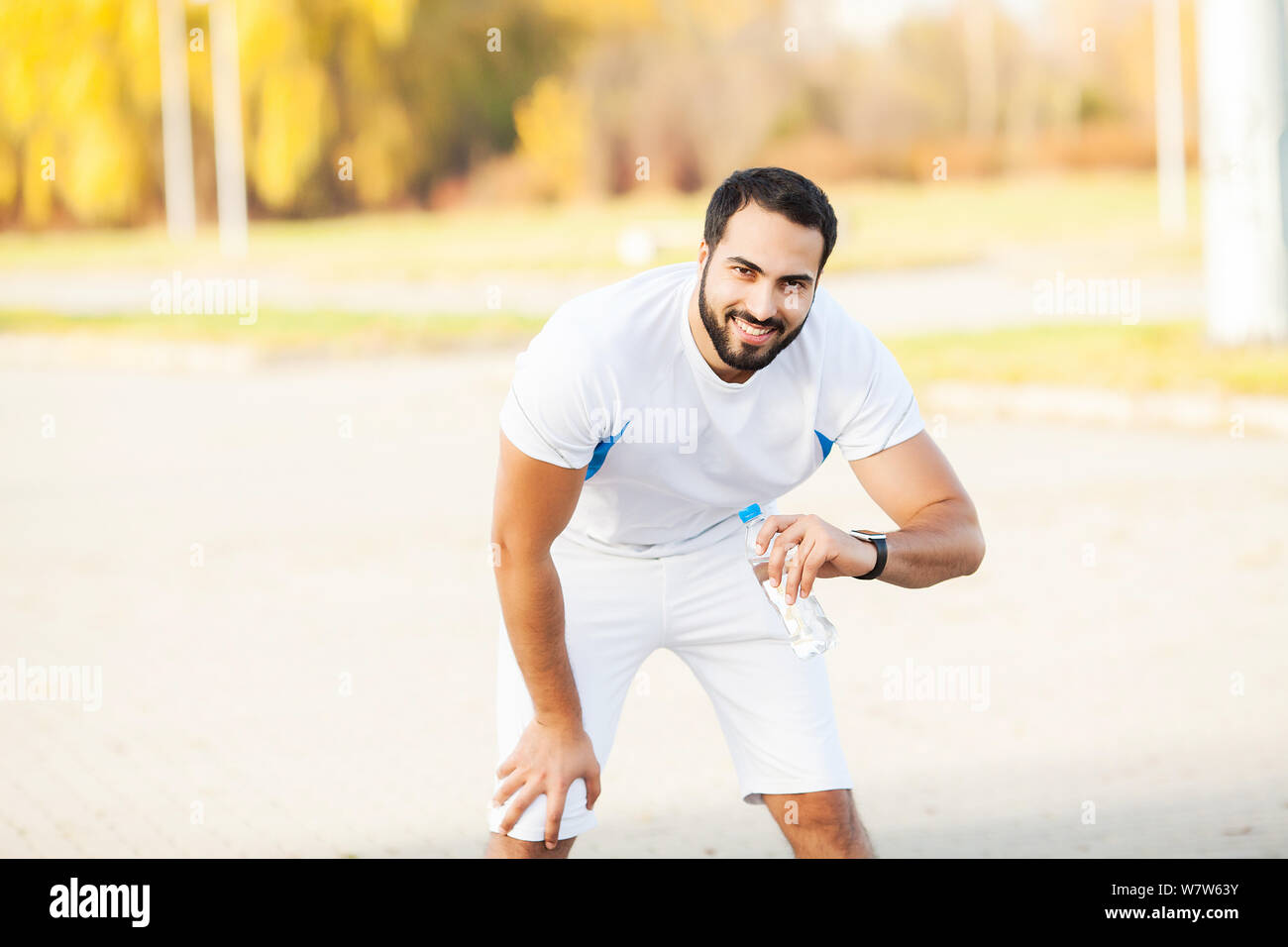 Fitness. Tired man runner rest after running on city stree Stock Photo ...