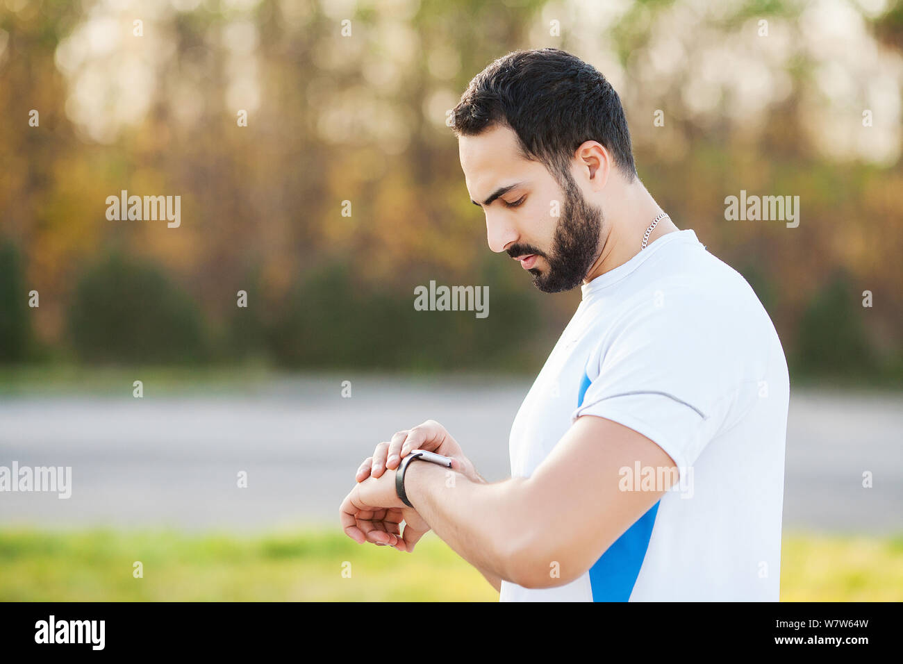 Fitness. Tired man runner rest after running on city stree Stock Photo ...