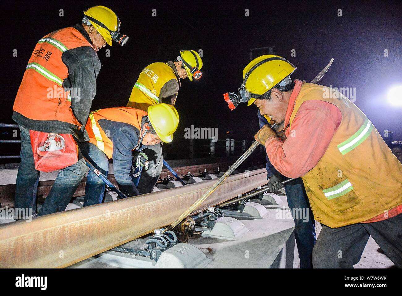 Chinese workers labor at the construction site of the high-speed ...