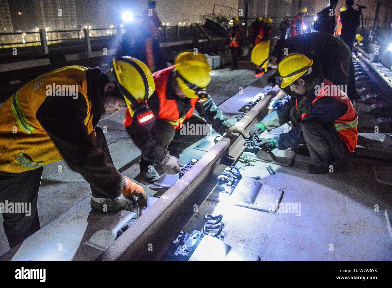 Chinese workers labor at the construction site of the high-speed ...