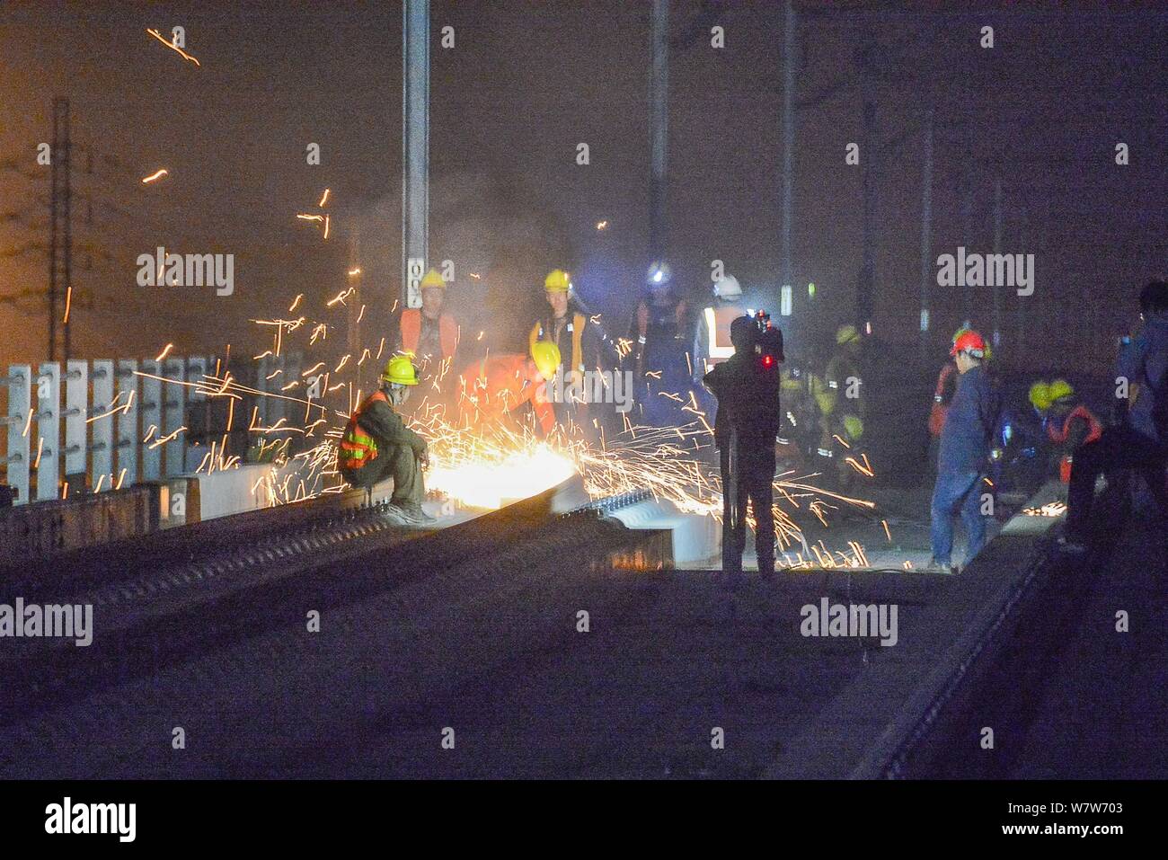 Chinese workers labor at the construction site of the high-speed ...