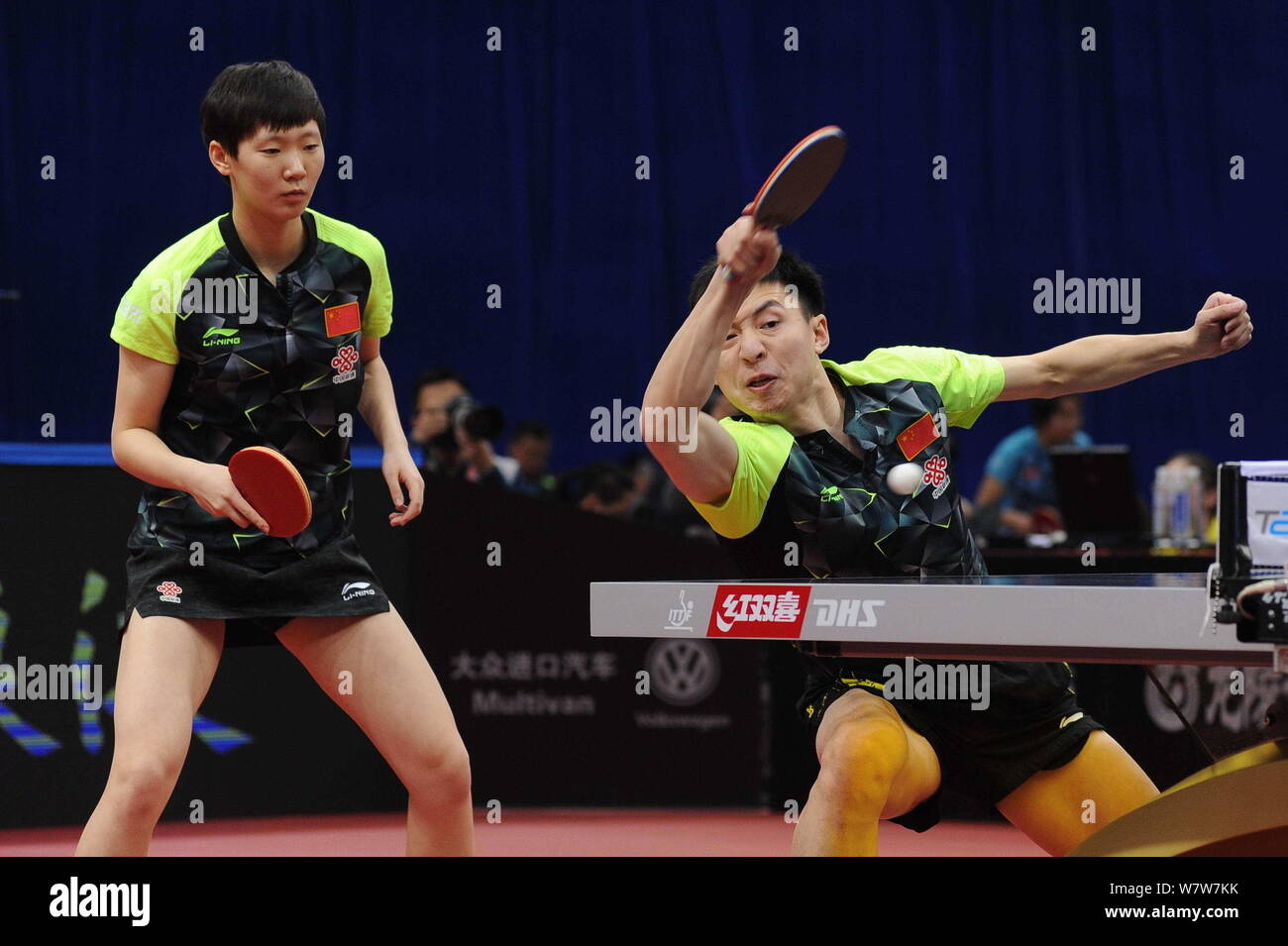 Fang Bo, right, returns a shot as he and Wang Manyu of China compete ...