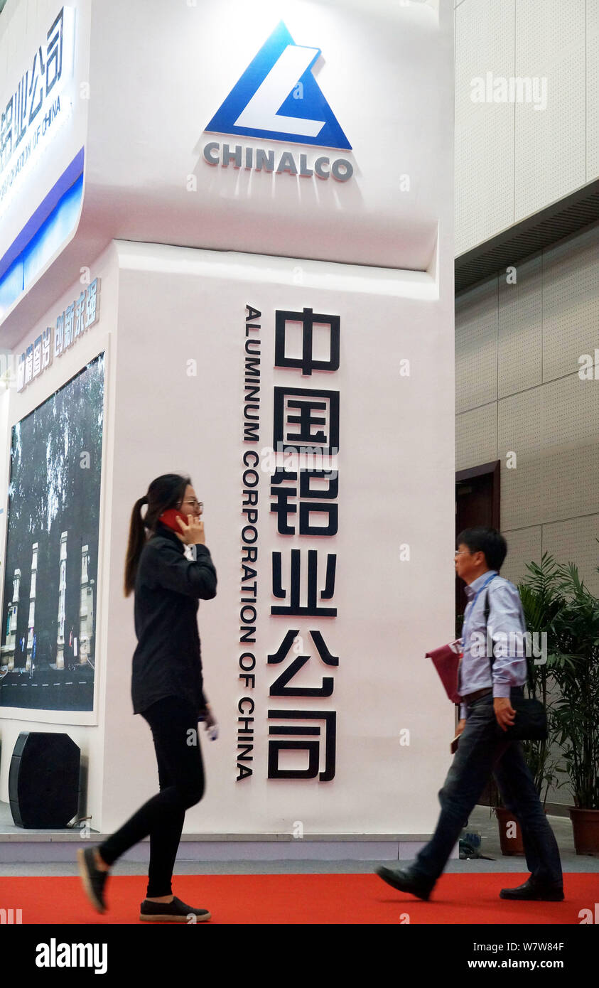 --FILE--Pedestrians walk past the signboard of Chinalco (Aluminum ...