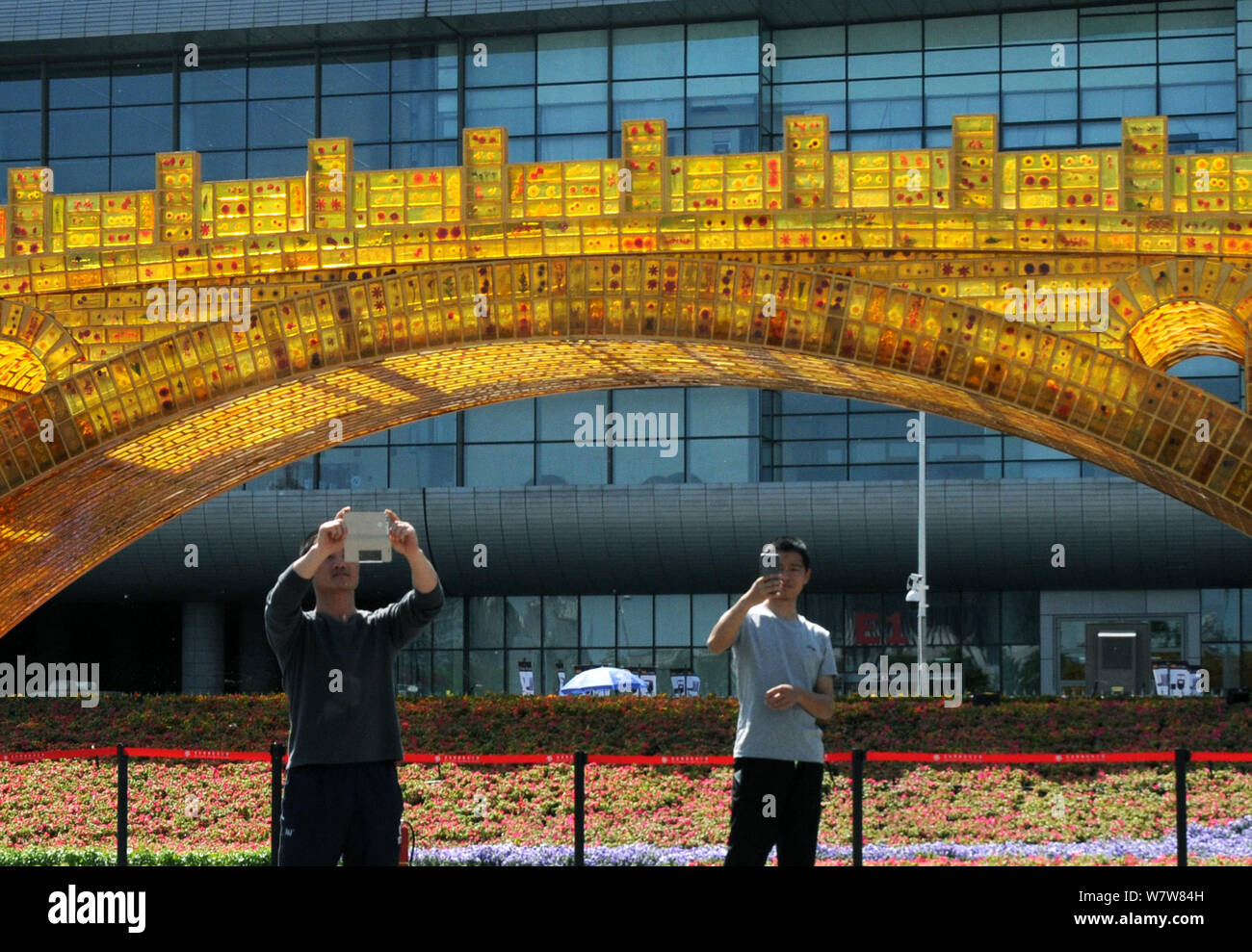 Visitors take photos of the newly built "Silk Road Golden Bridge" at ...