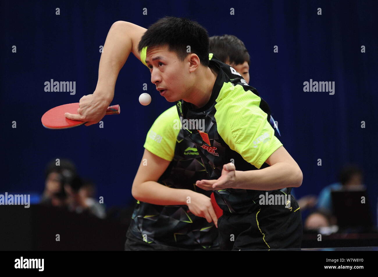 Fang Bo, front, serves as he and Wang Manyu of China compete against ...