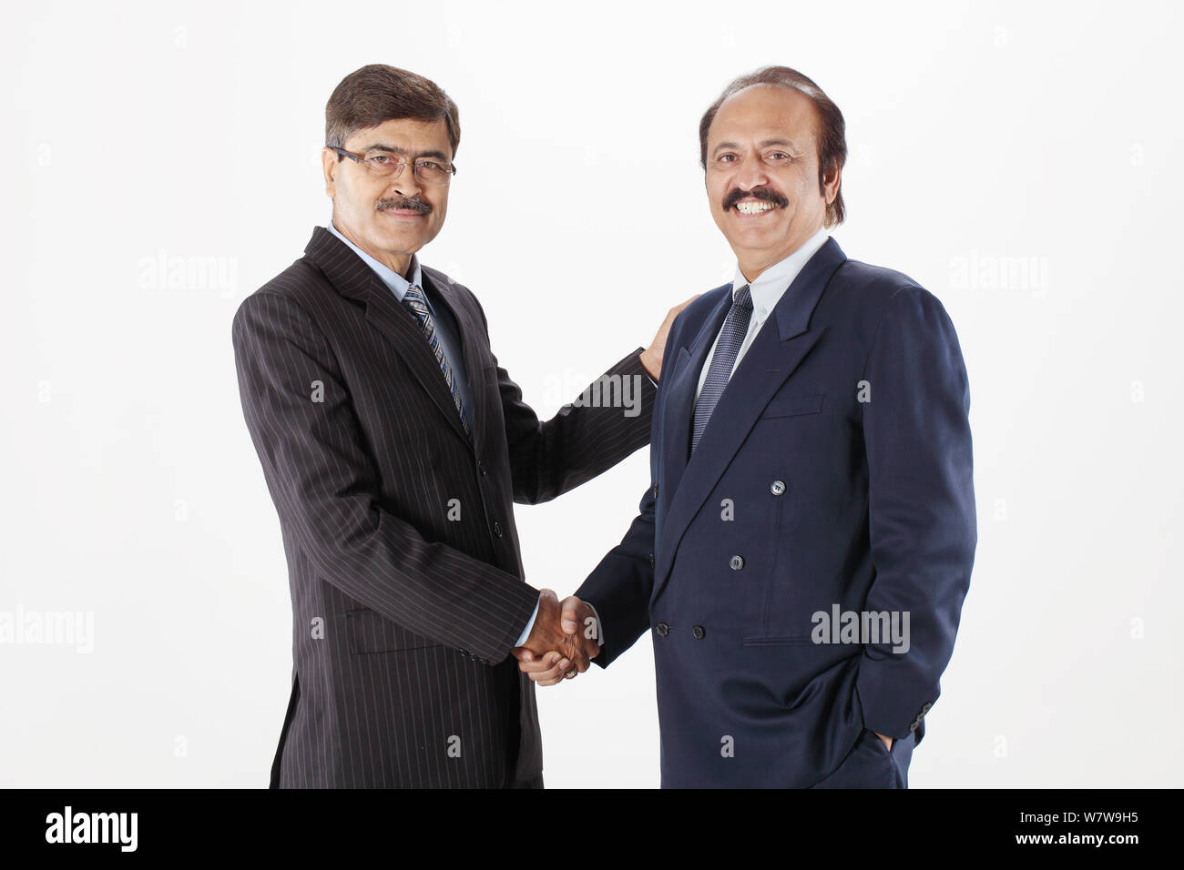Two business executives shaking hands Stock Photo - Alamy