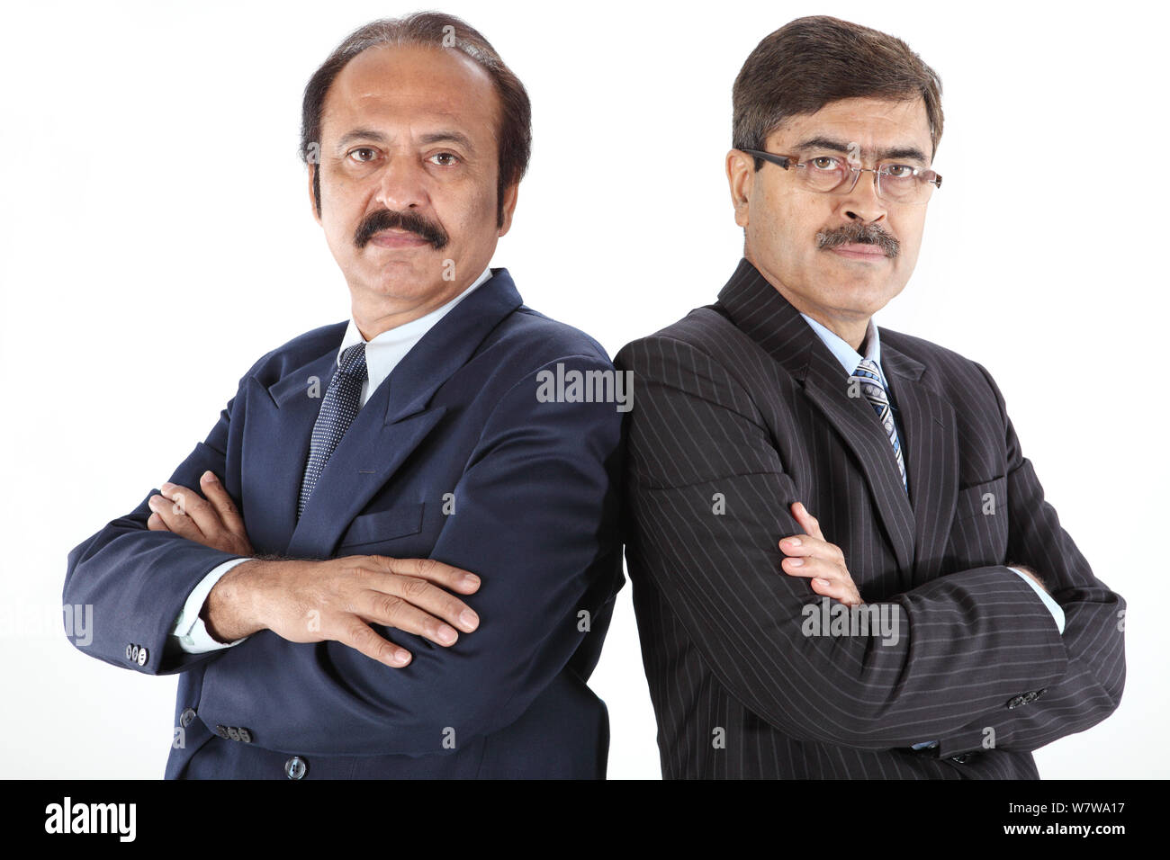 Two business executives standing back to back Stock Photo - Alamy