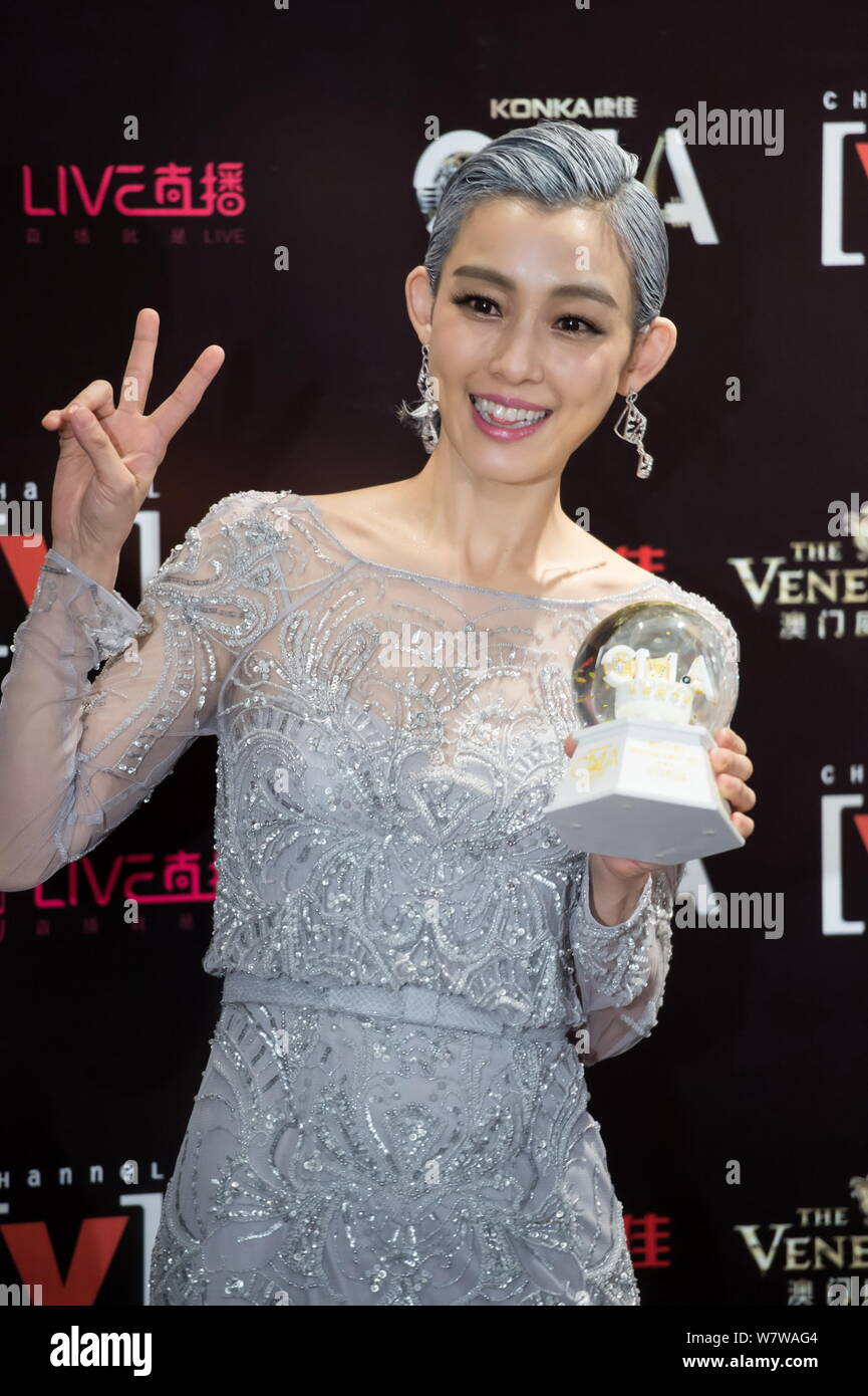 Taiwanese singer and actress Christine Fan poses with her trophies ...