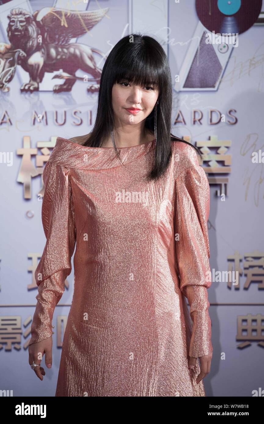 Chinese singer Tan Weiwei poses on the red carpet for the 21st China ...