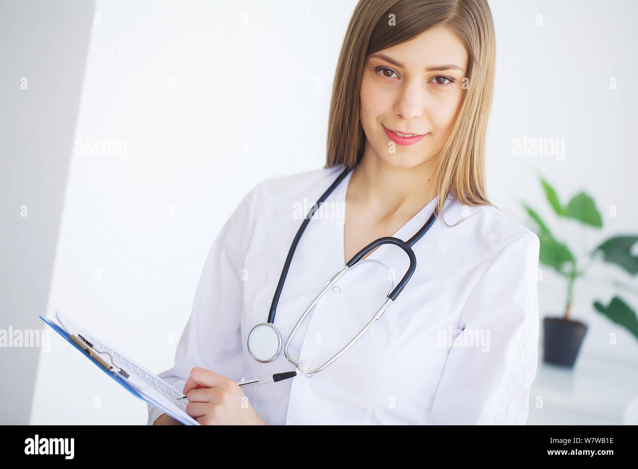 Health concept. Young female doctor on modern clinic background Stock ...