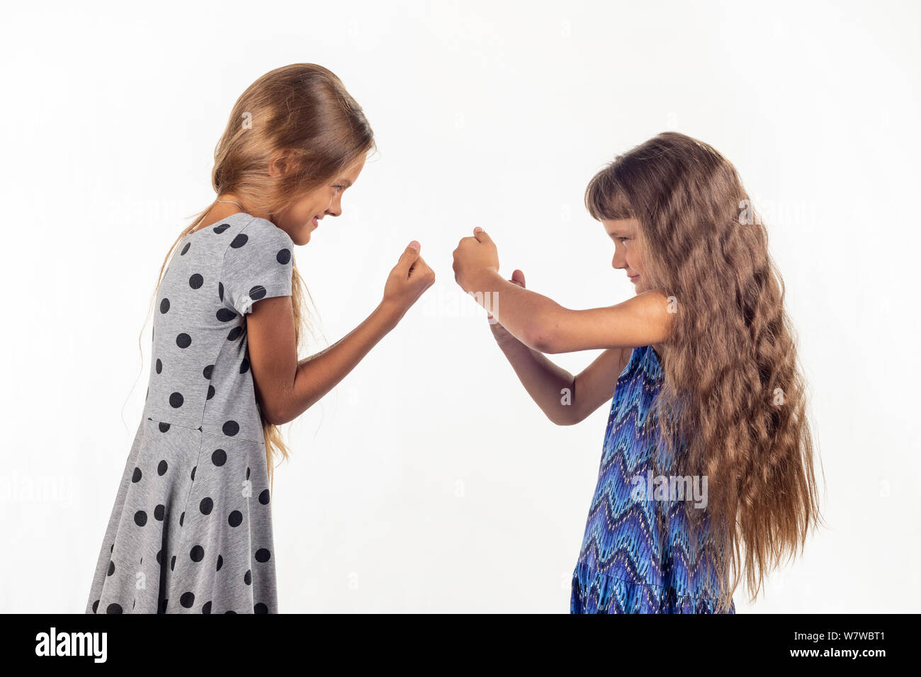 Two girls are fighting, studio white background Stock Photo - Alamy